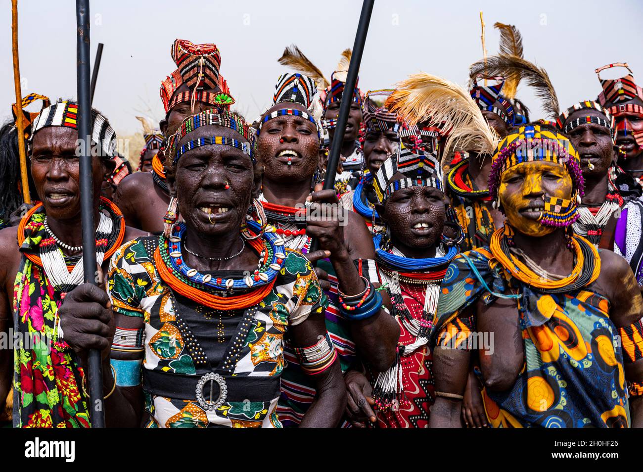 Traditional dressed women of the Jiye tribe dancing and singing ...