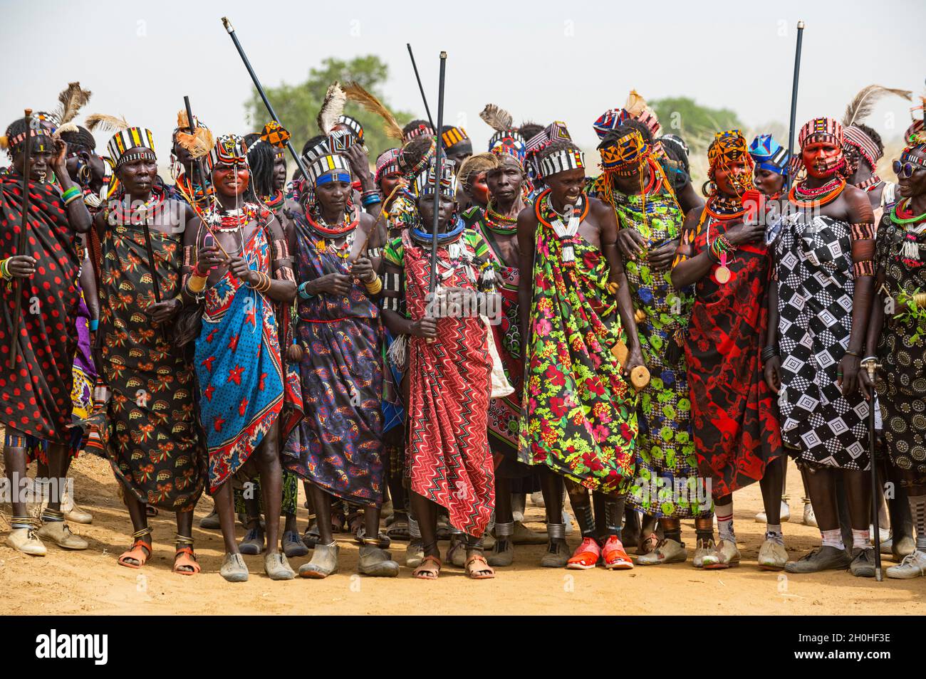 Traditional dressed women of the Jiye tribe dancing and singing ...
