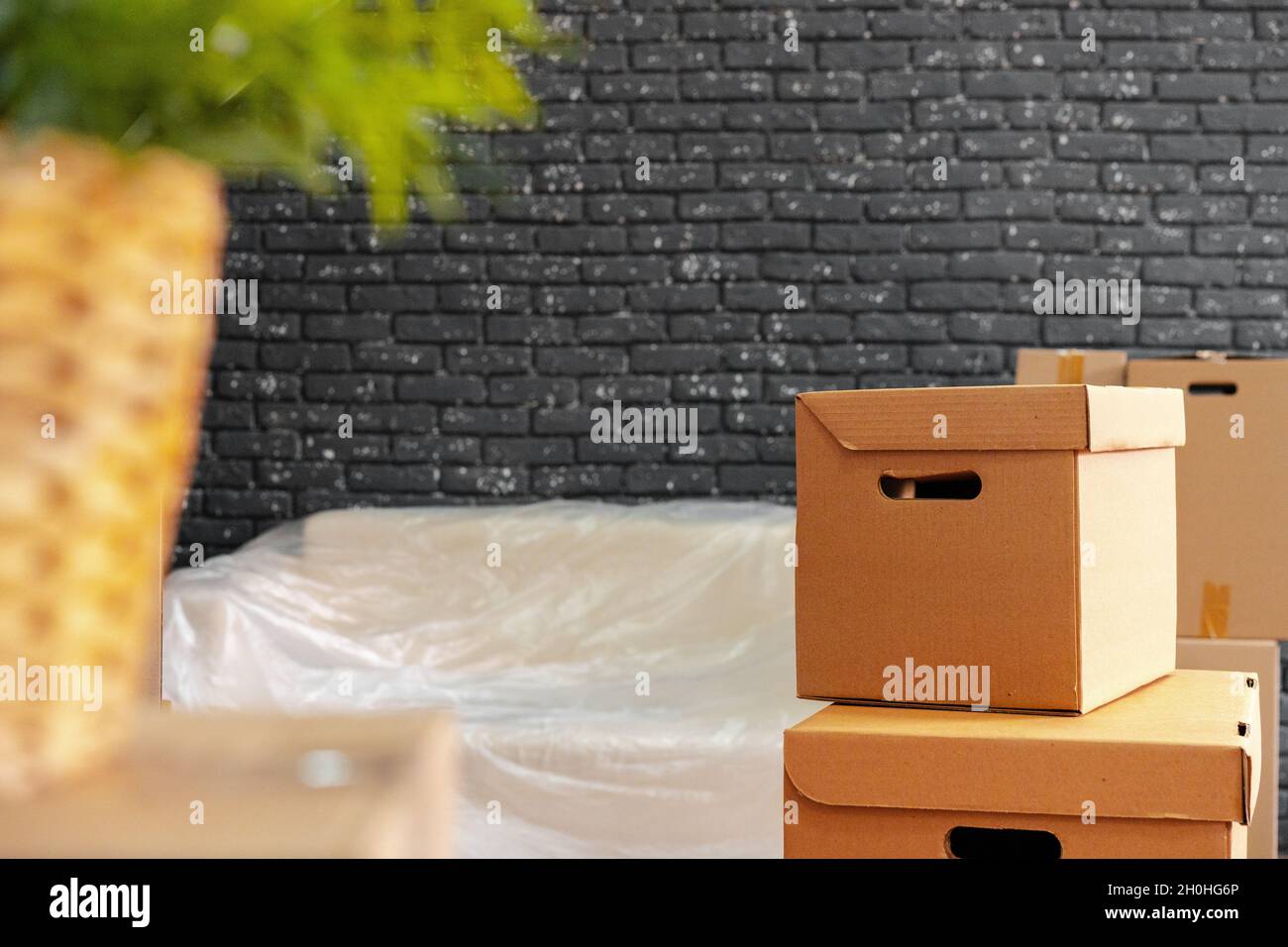 Moving in or moving out concept. Stack of boxes and packed furniture ...