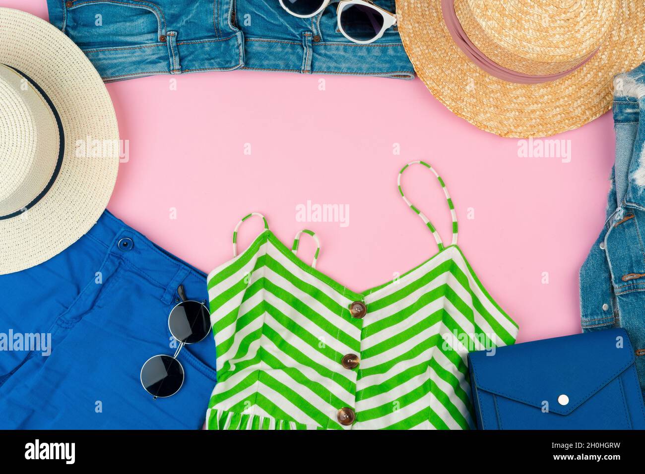 Set of summer clothes for woman on pink background Stock Photo - Alamy