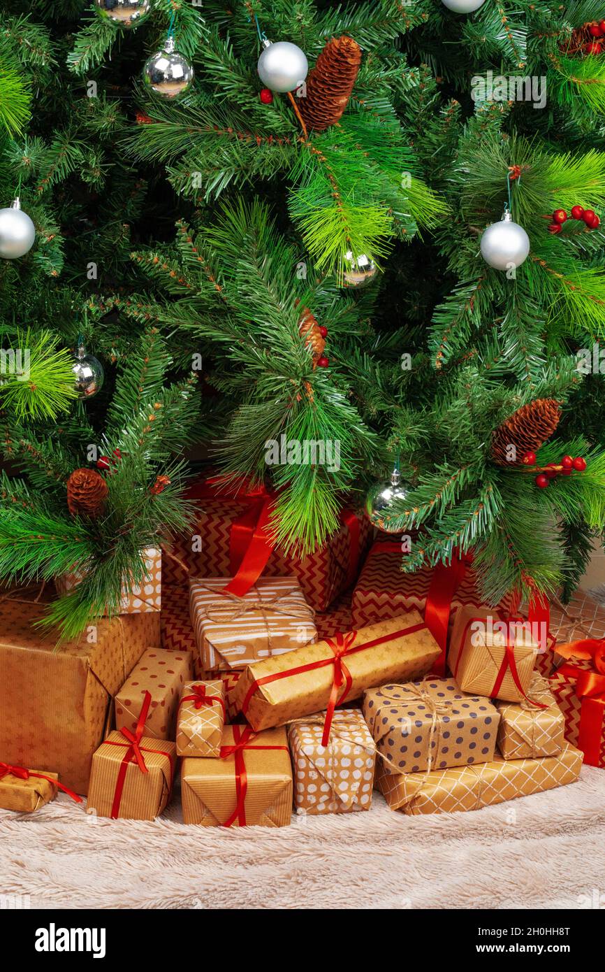 Stack of wrapped presents under Christmas tree Stock Photo - Alamy