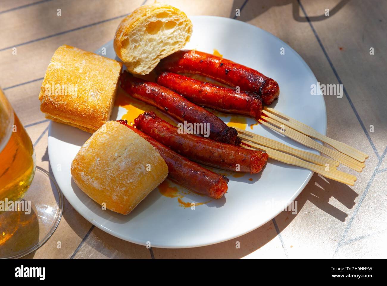 Mildly spiced grilled mini sausages chistorra. Tapa from Basque Country ...