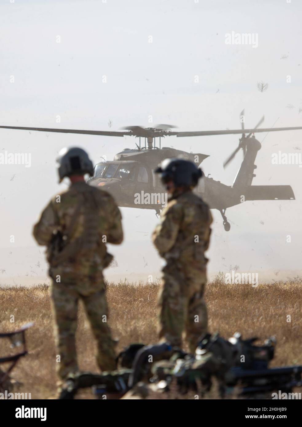 Soldiers assigned to 10th Special Forces Group (Airborne) watch a UH-60 ...