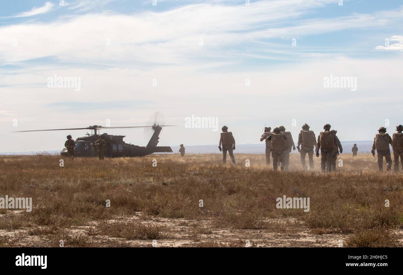 Soldiers assigned to 10th Special Forces Group (Airborne) board a UH-60 ...