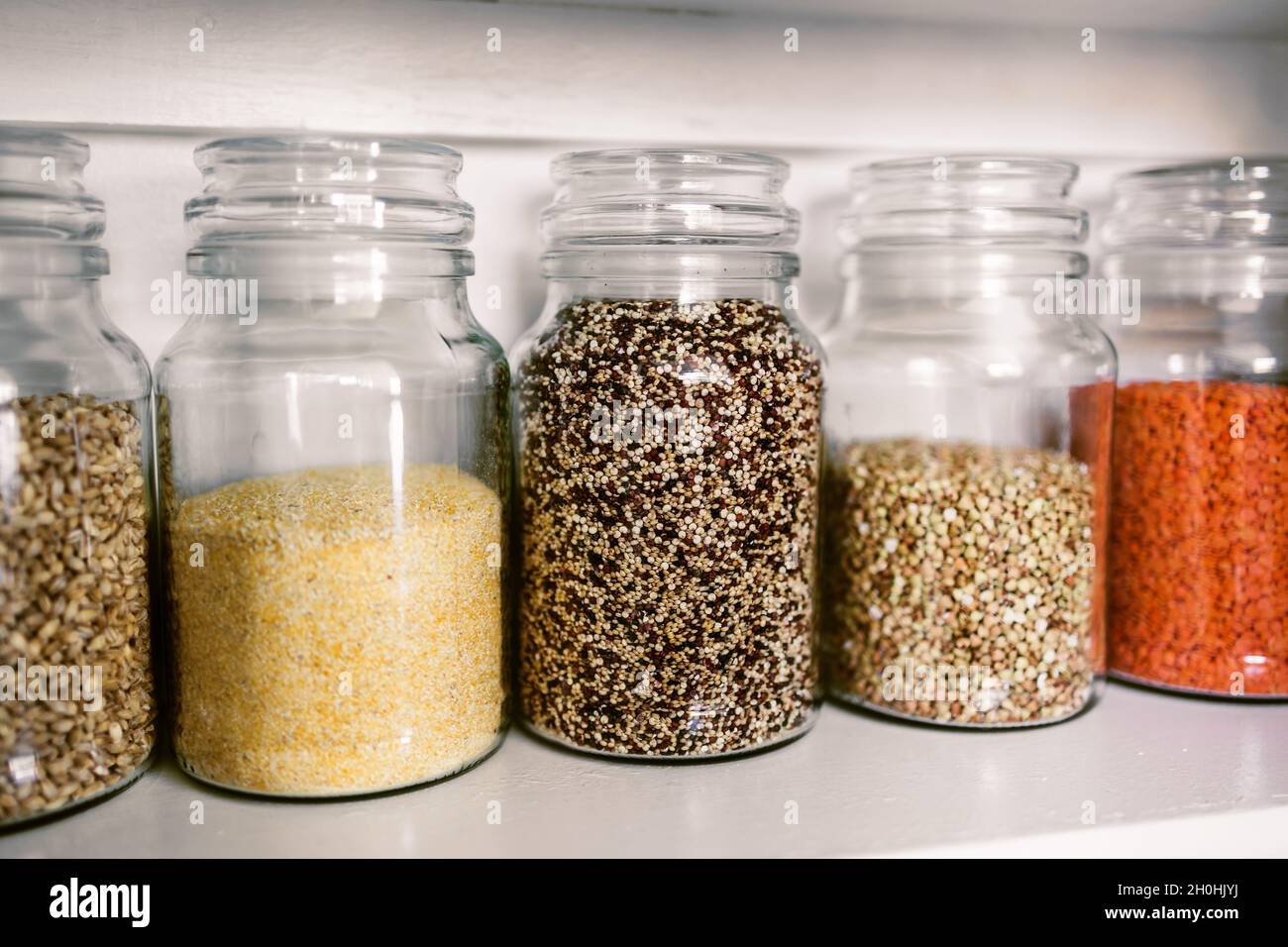 clear pantry jars with different types of grains and healthy ...