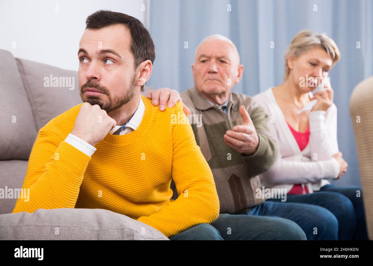 Parents arguing with son Stock Photo - Alamy