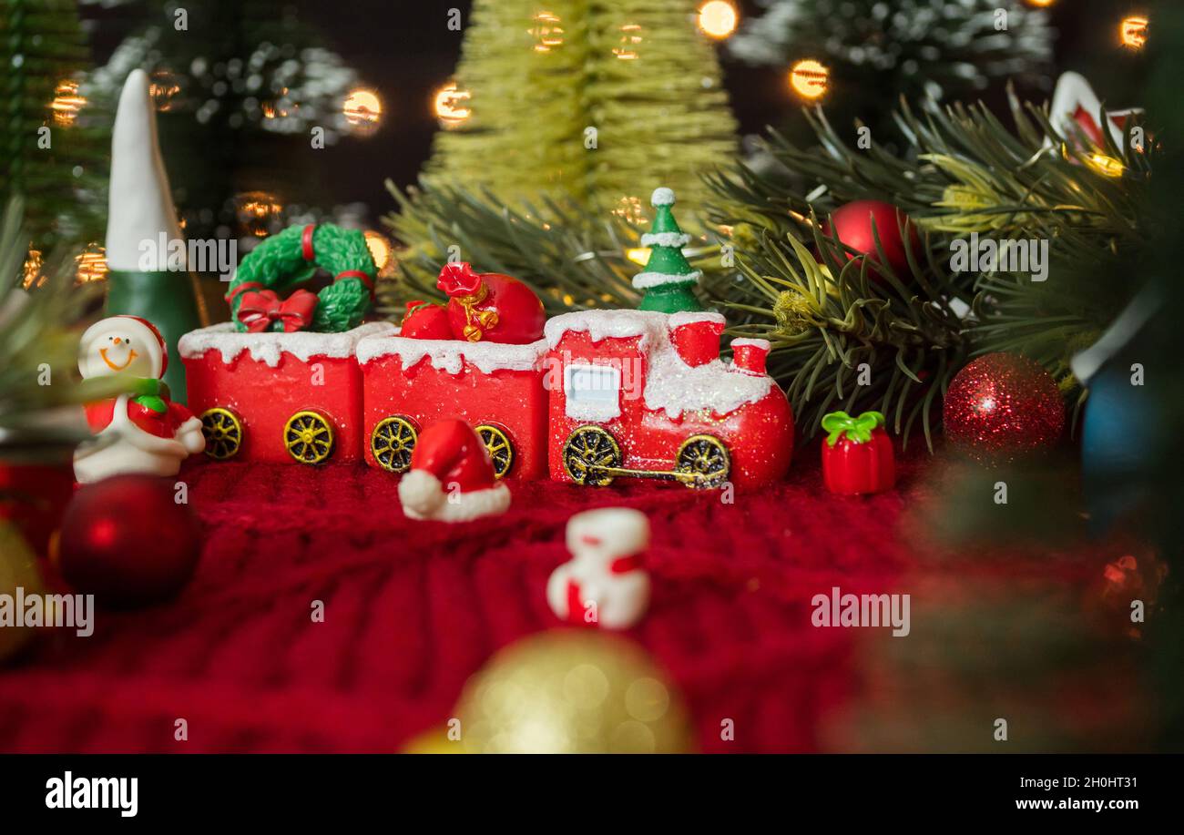 Christmas train and decorations on red yarn wool Stock Photo - Alamy