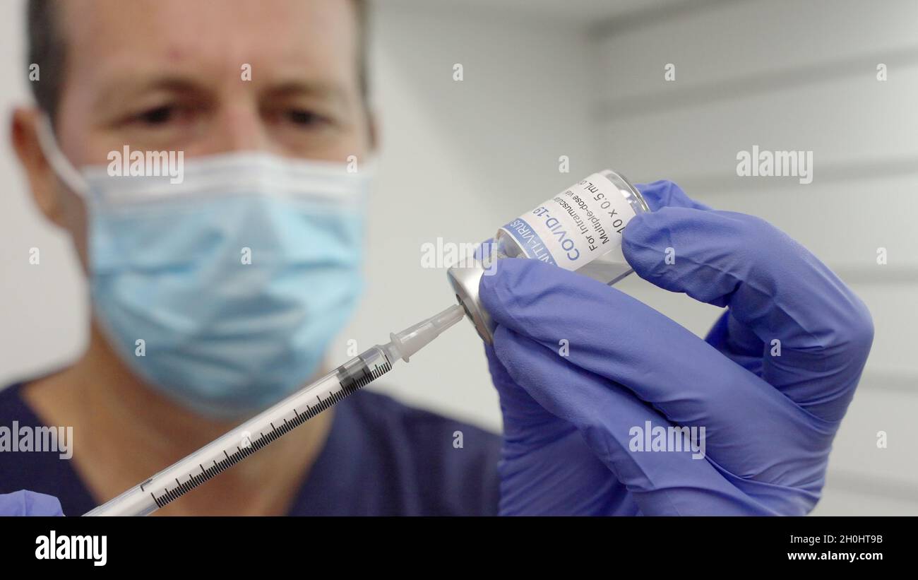 shallow dof shot of a male with a covid-19 vial and syringe Stock Photo ...