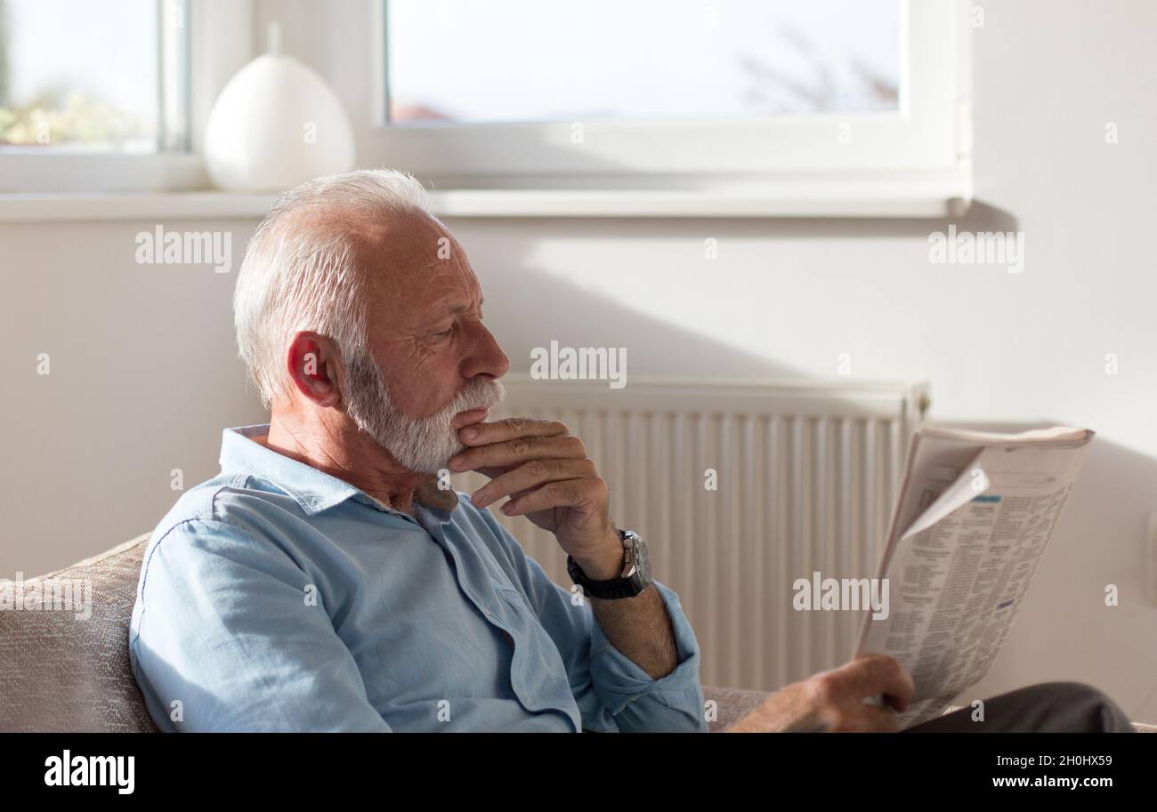 Older person reading newspaper at home hi-res stock photography and ...