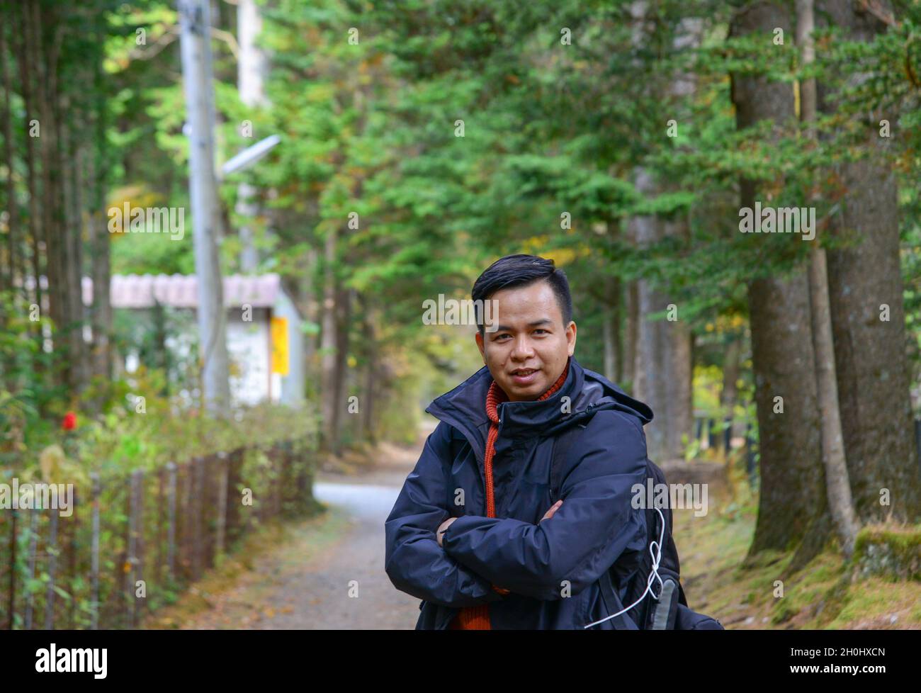 Young Asian man walking on rural road in Karuizawa, Japan Stock Photo ...