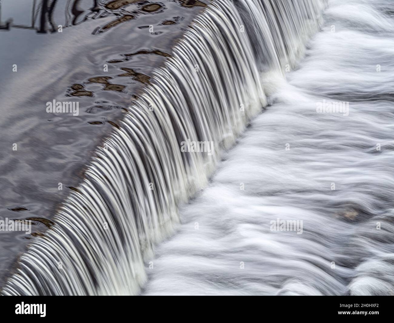 A small flat cascade in a calm river. Water background Stock Photo - Alamy