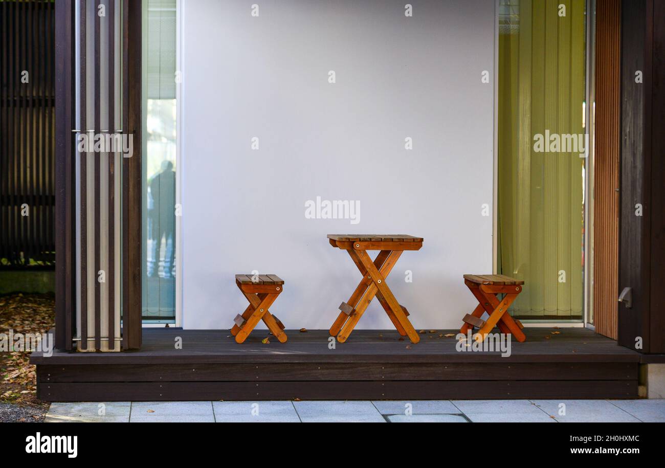 Wooden tables and chairs placed in front of the modern house Stock ...