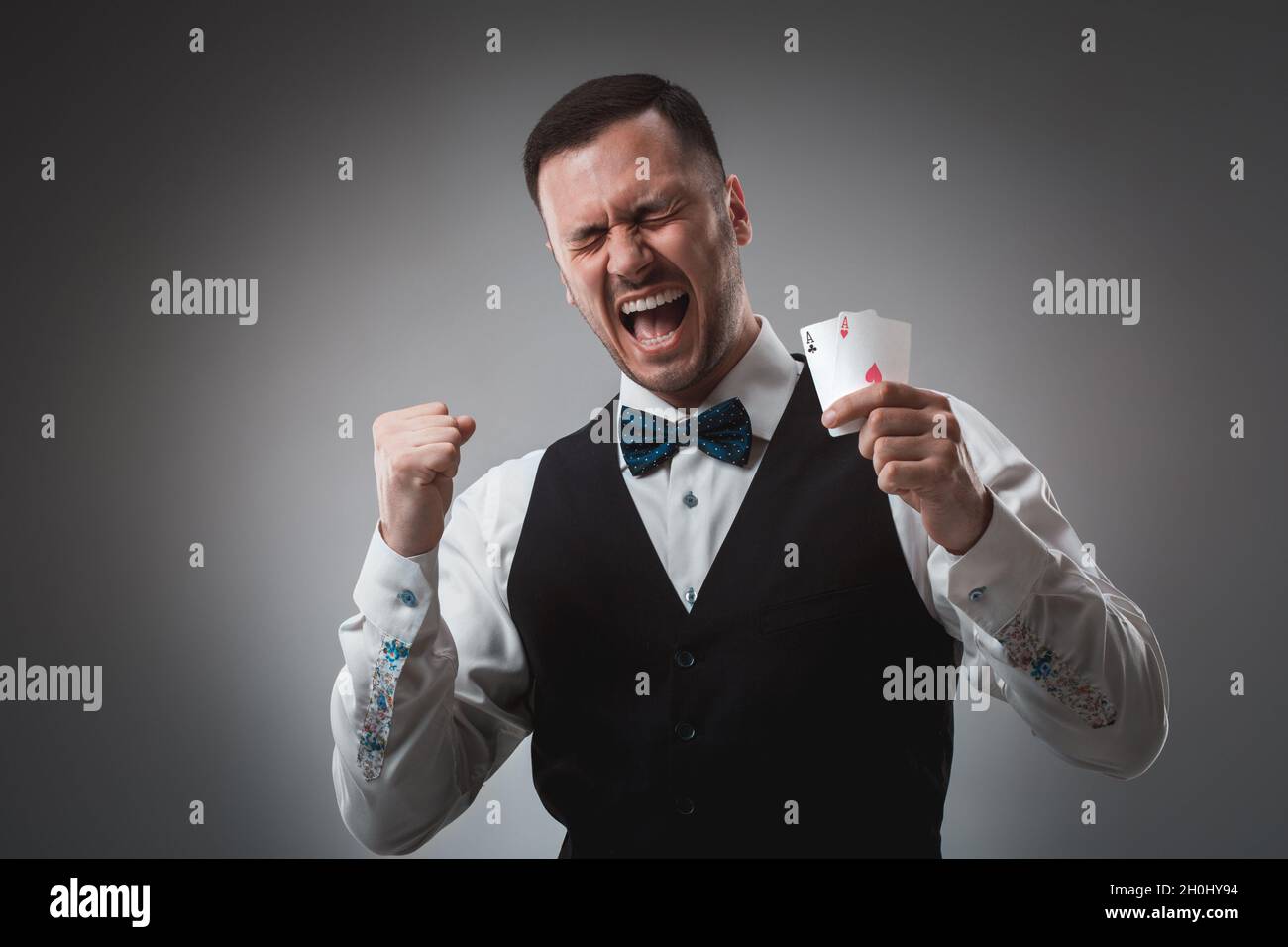 Handsome confident man holding cards looking at camera Stock Photo - Alamy