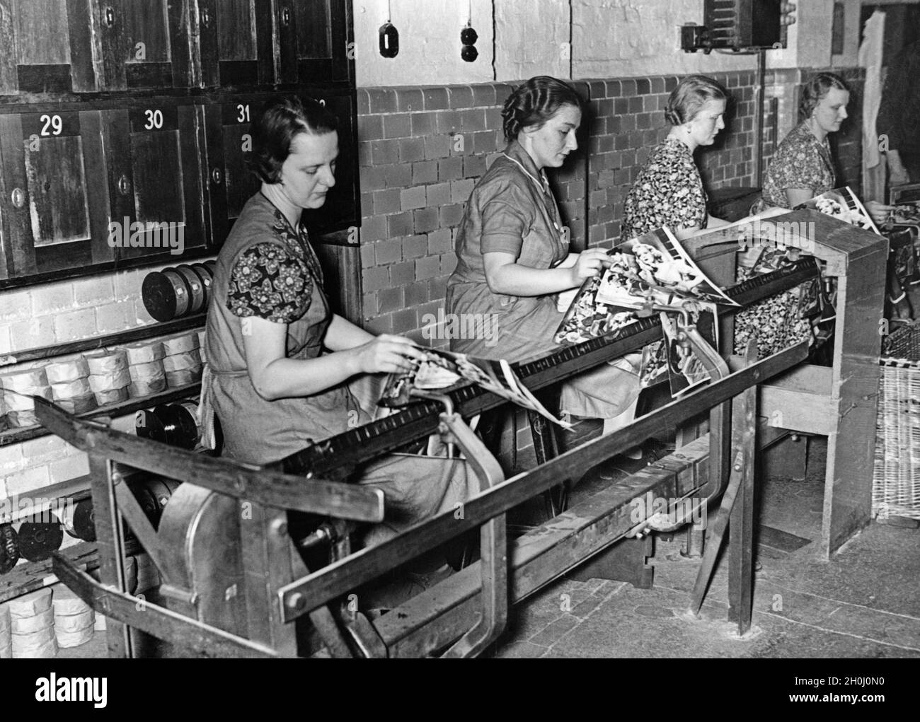 Workers on the assembly line, including the Social Worker (2nd from ...