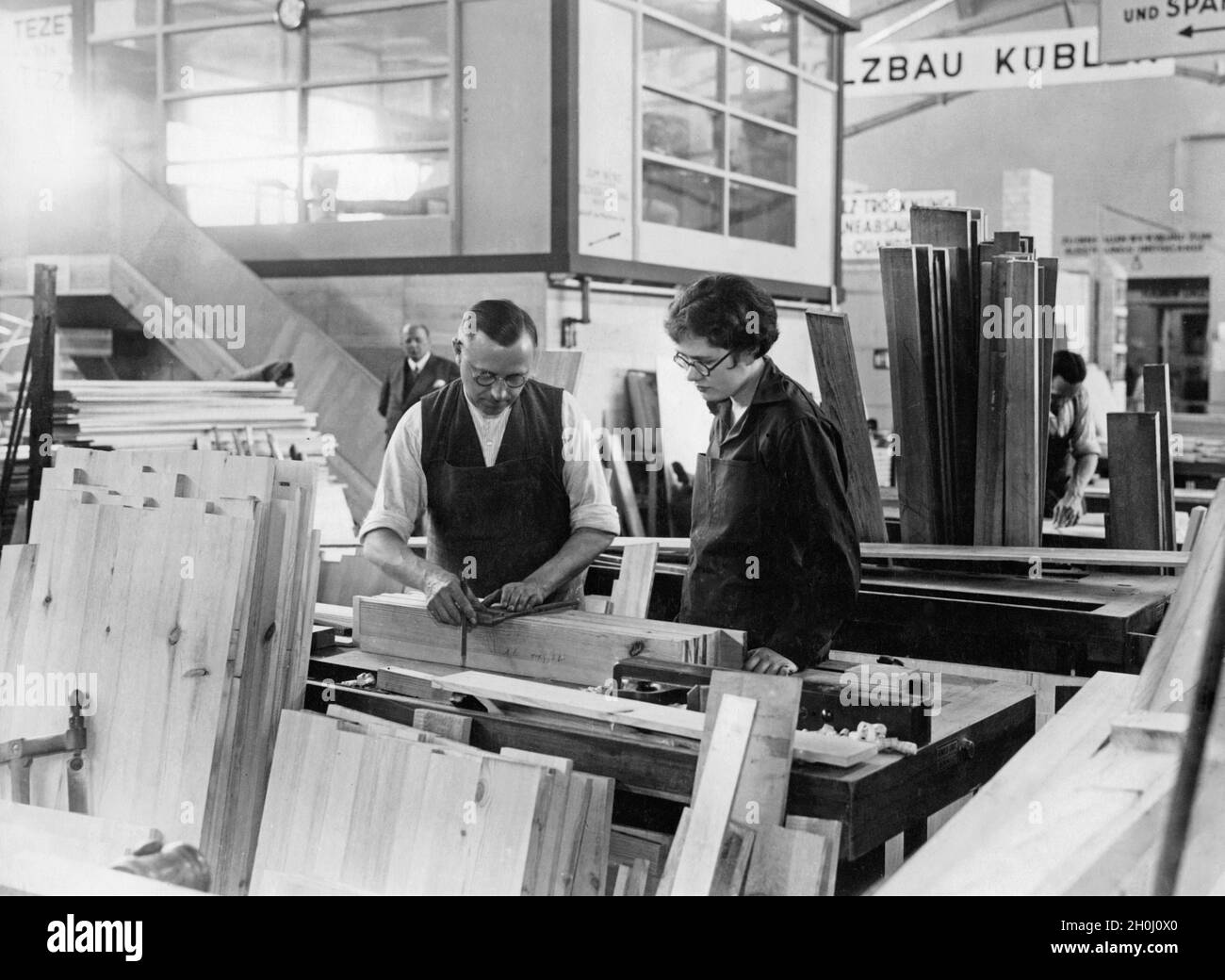 An apprentice carpenter at a building exhibition in 1931. [automated ...