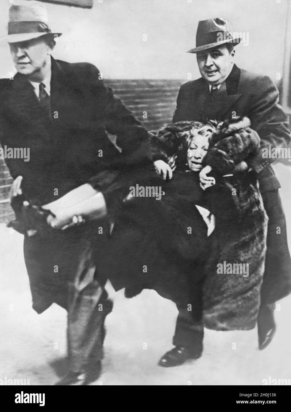 Police carry woman riots hi-res stock photography and images - Alamy