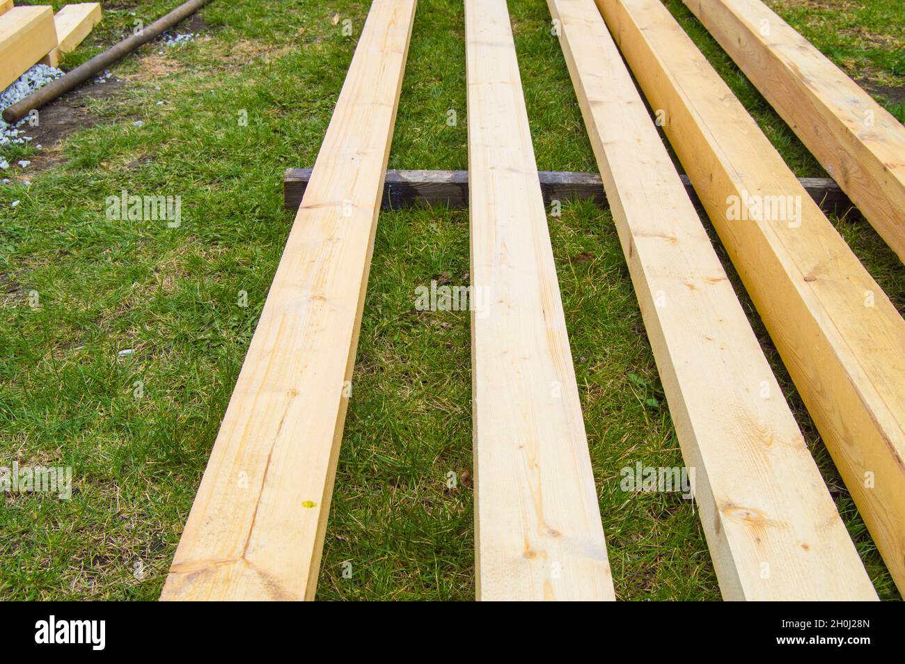 New wooden boards on the grass. Lumber for suburban construction Stock ...