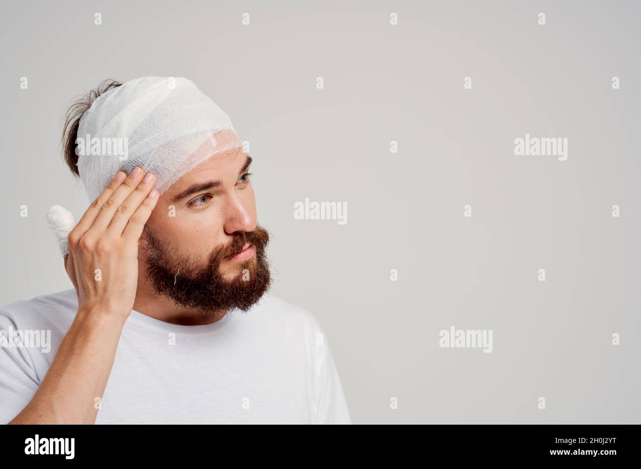 patient bandaged head and hand blood light background Stock Photo - Alamy