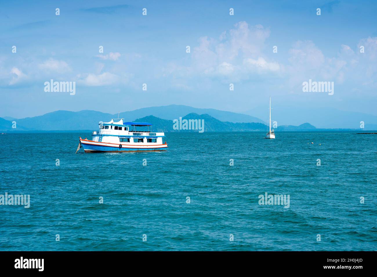 Beautiful sea view with boat against blue sky Stock Photo - Alamy