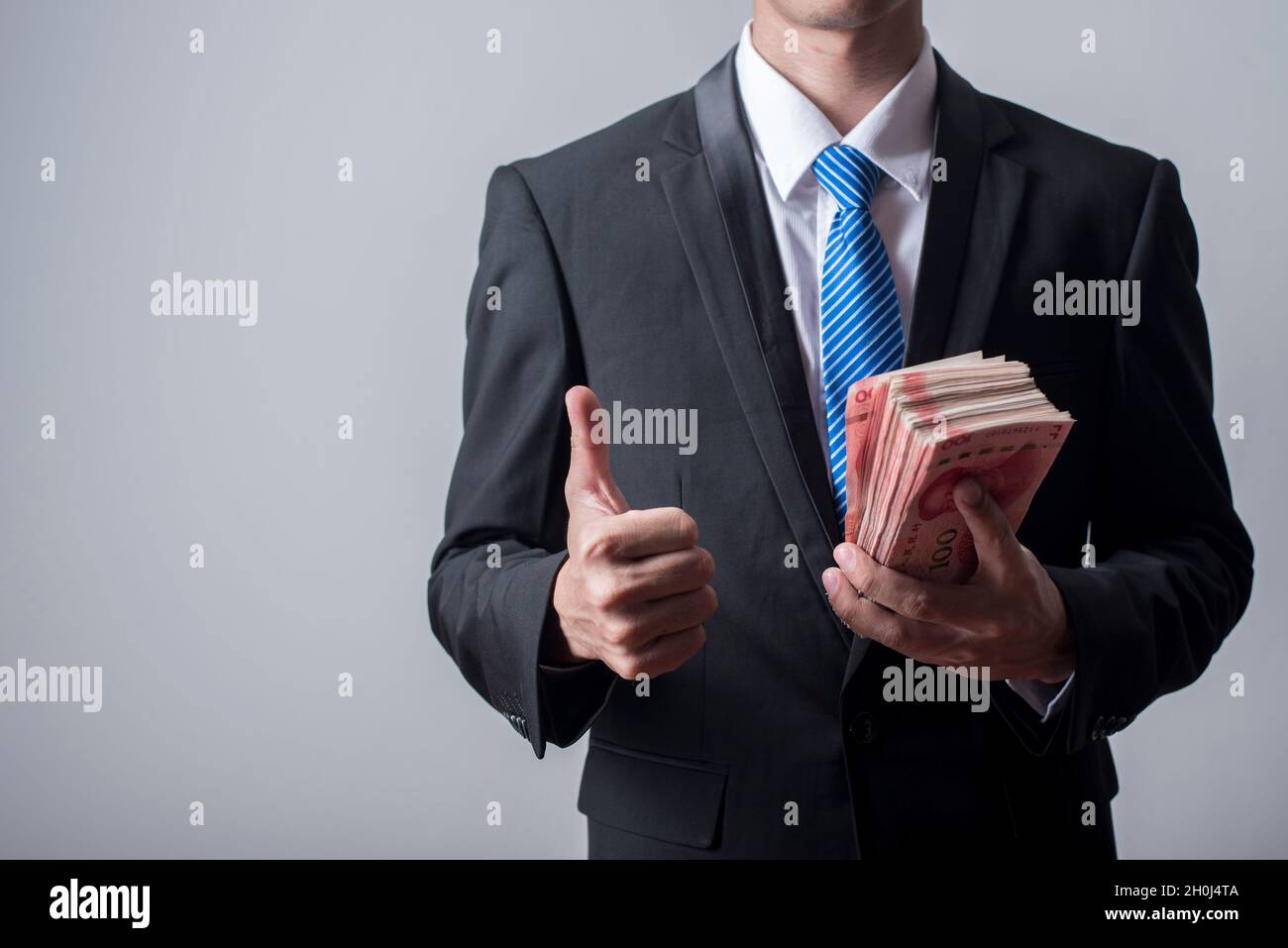 Business man holding China money Stock Photo - Alamy