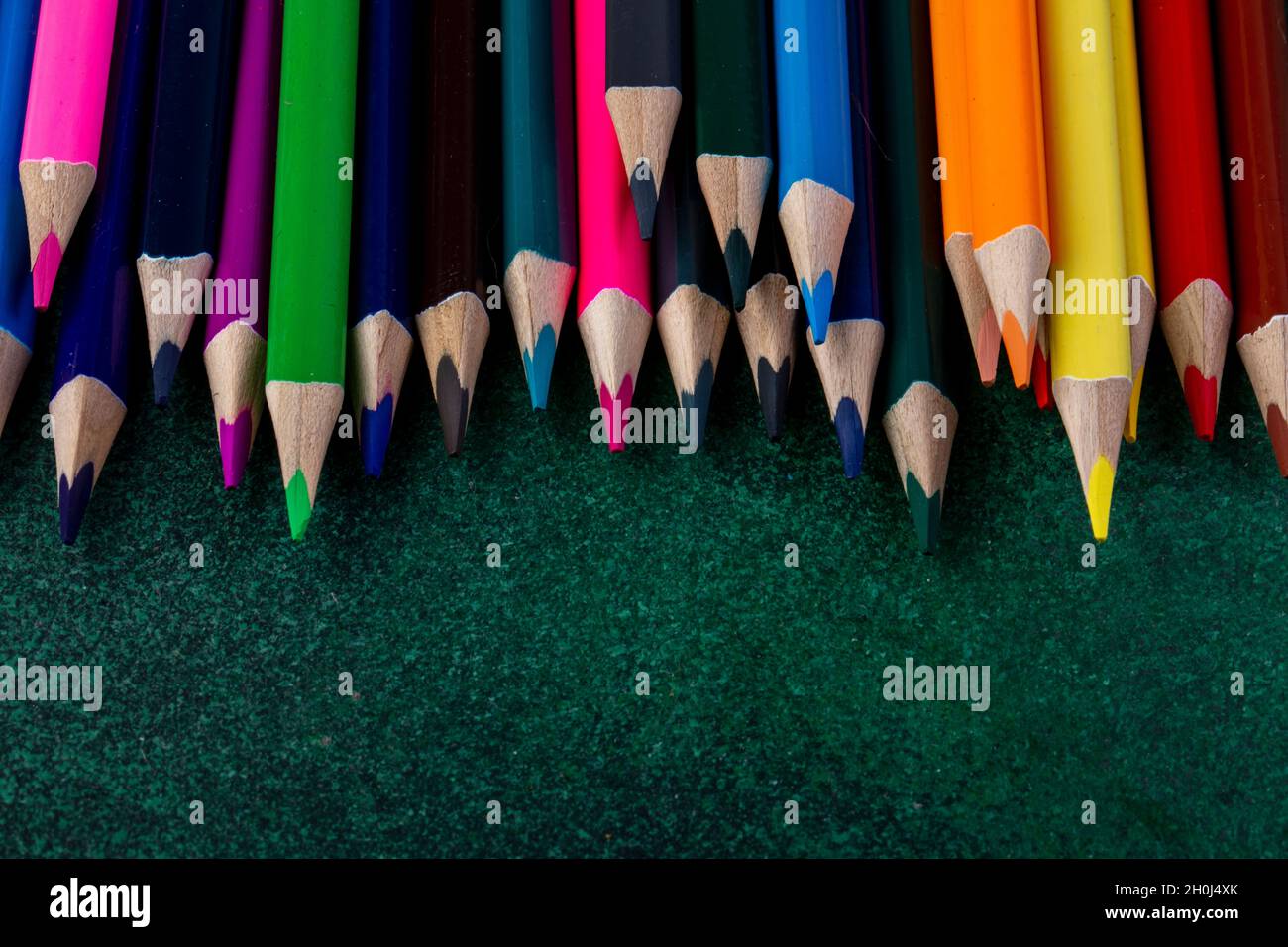 side view of a set of colored pencils on dark background Stock Photo ...