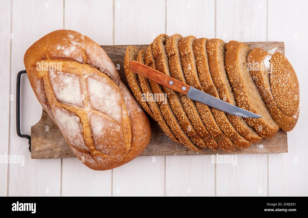 top view of breads as sliced brown seeded cob and crusty bread with ...