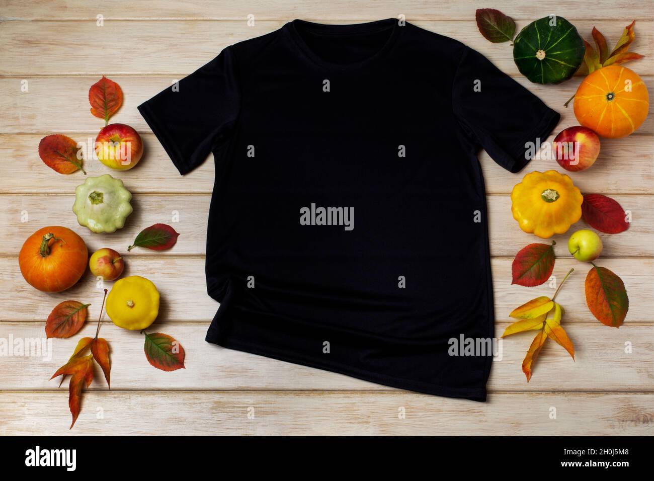 Black unisex cotton T-shirt mockup with fall leaves, apples, yellow ...