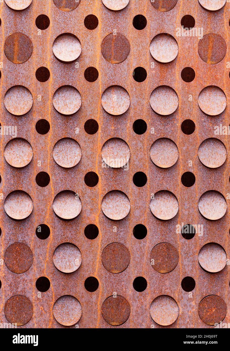 Old metal sheet with rust texture and symmetrical round holes ...