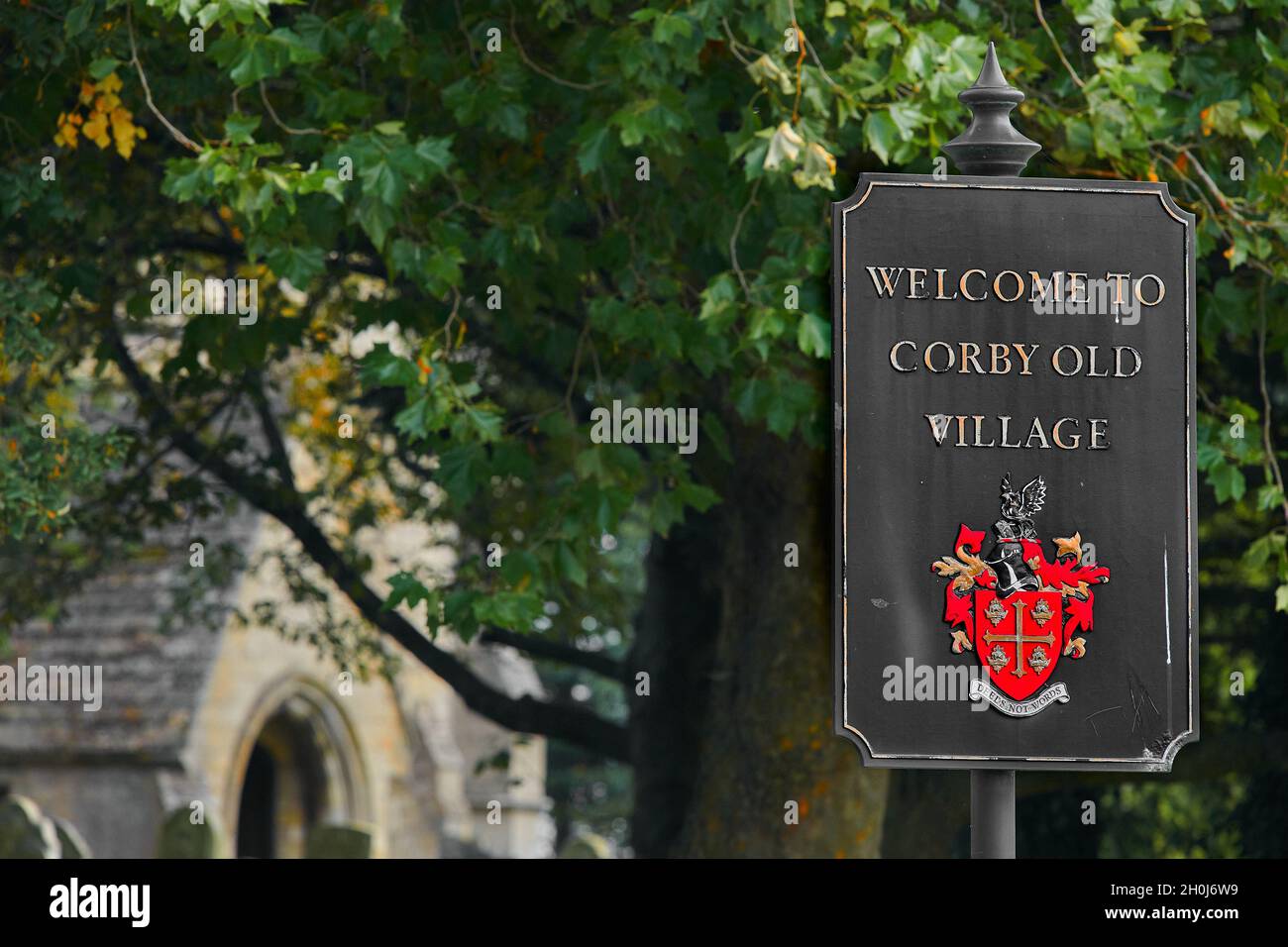 Sign with motto and badge in Corby Old Village, England Stock Photo - Alamy