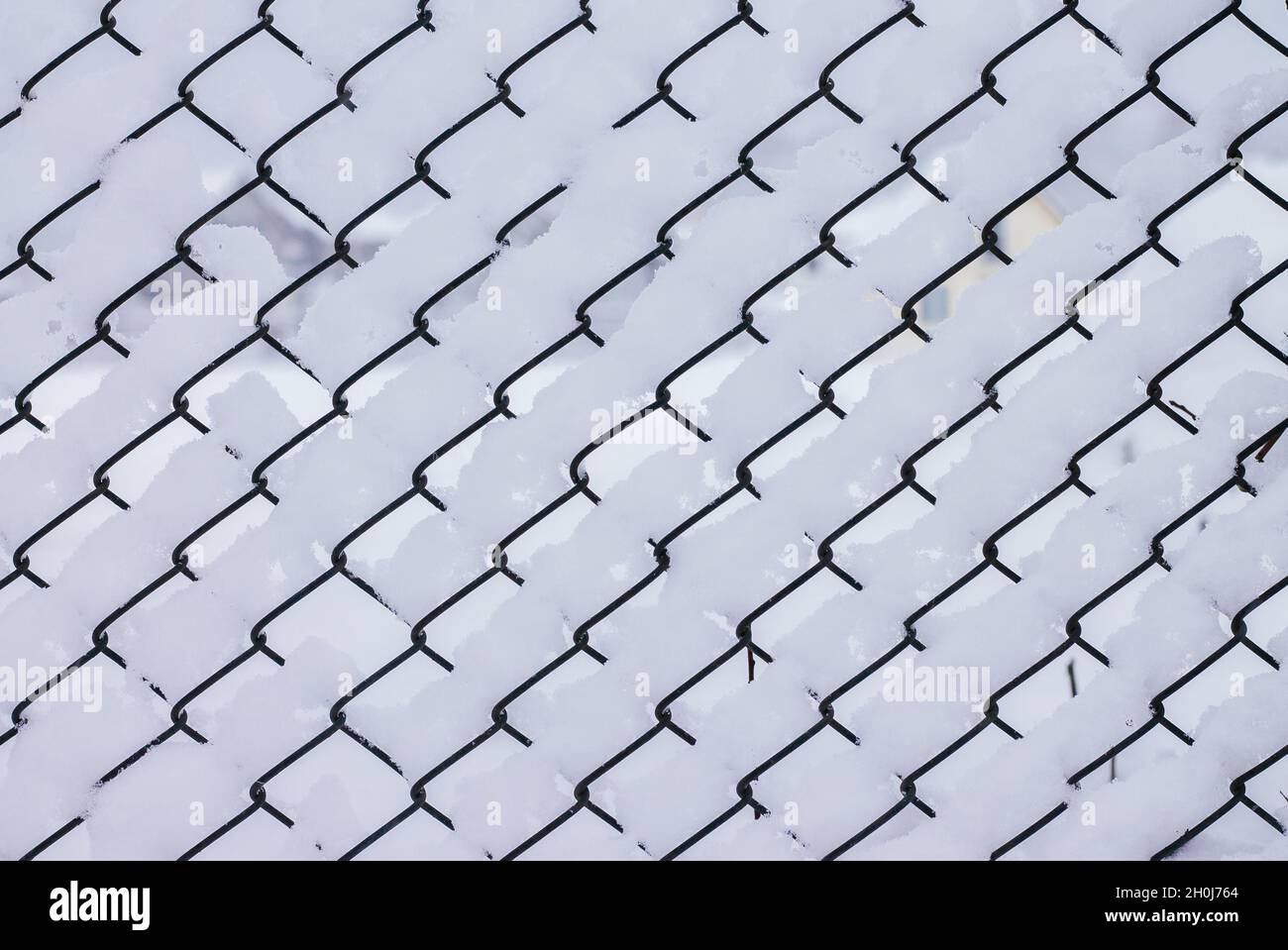 Winter creative background image. Snow lying on mesh cells of chain ...