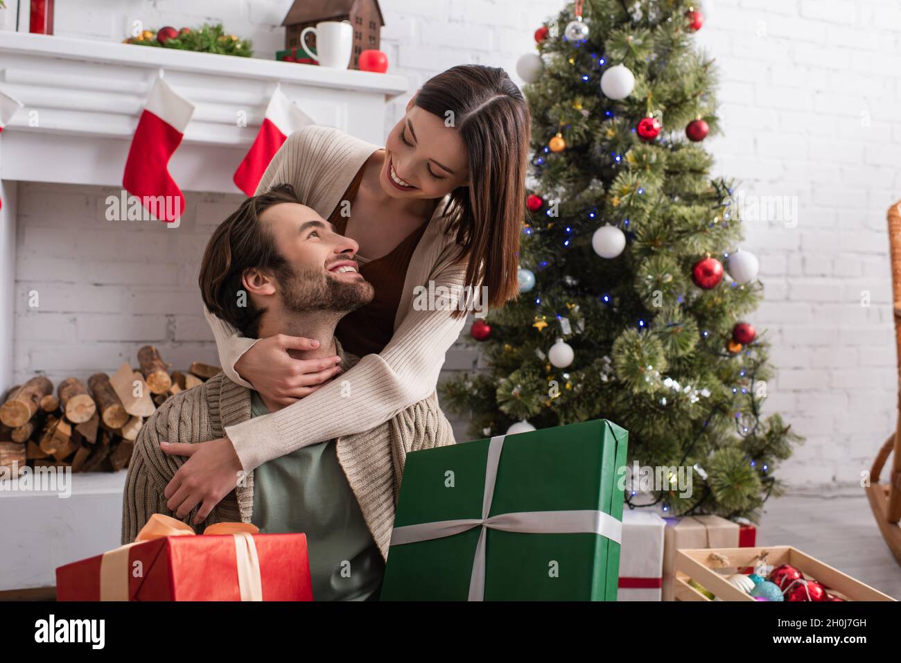 Young woman embracing gift hi-res stock photography and images - Alamy