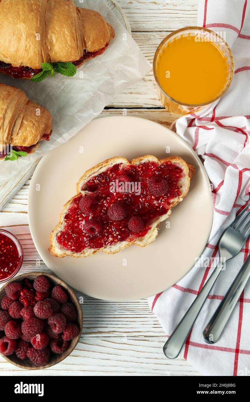 Concept of delicious food with croissants with raspberry jam on white ...