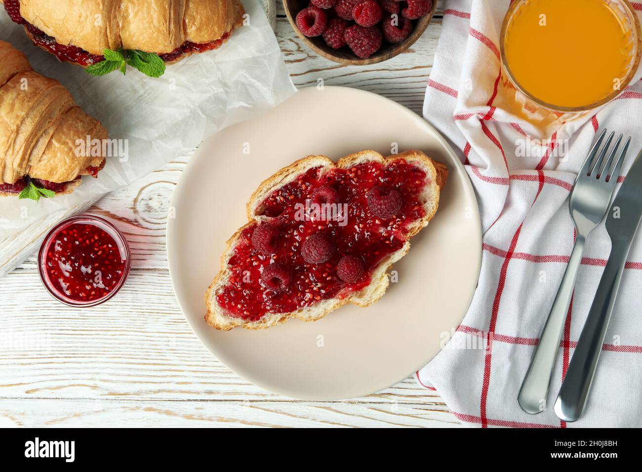 Concept of delicious food with croissants with raspberry jam on white ...