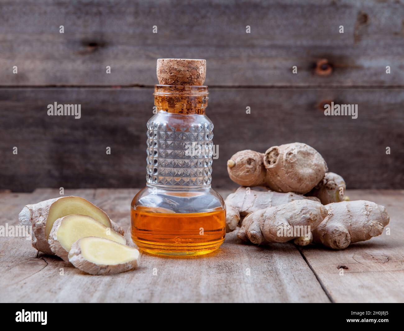 Alternative medicine and nature spas ingredients - Ginger root and ginger essential oil set up ...
