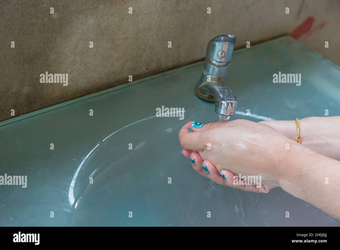 Women were nail washing hands with Liquid soap under running water and ...
