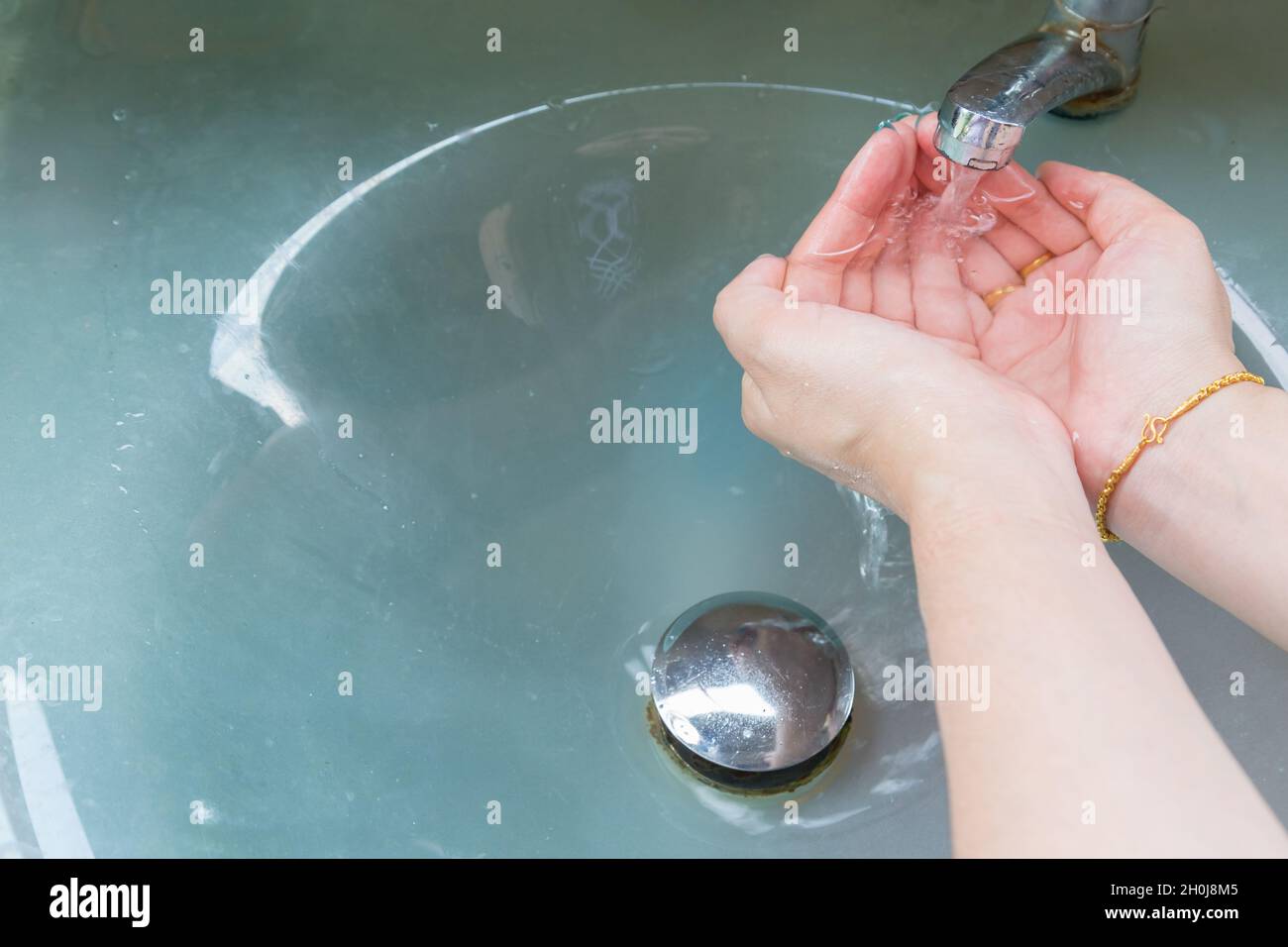 Women were nail washing hands with Liquid soap under running water and ...