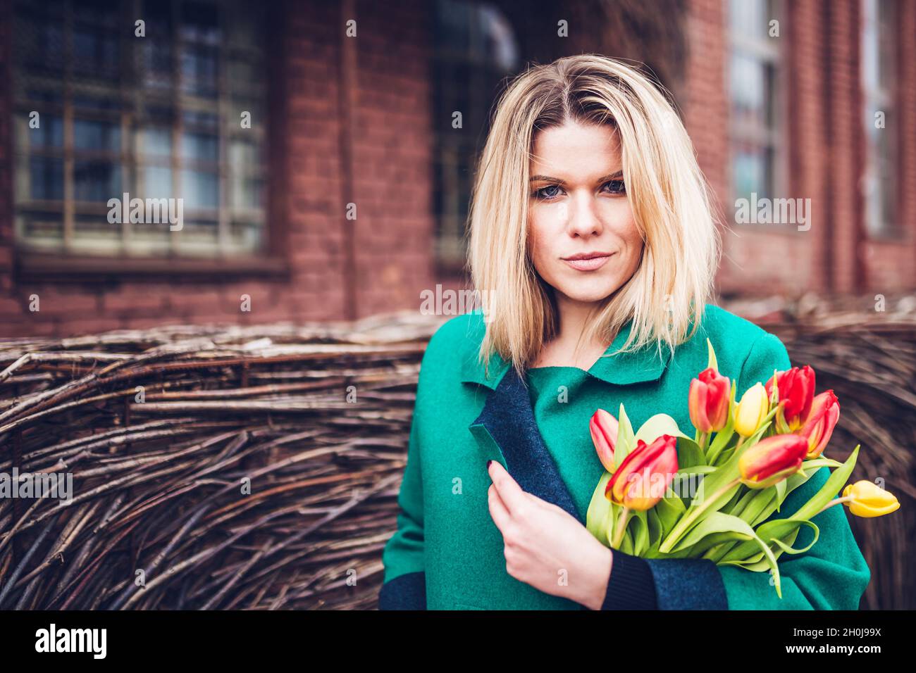 Attractive pretty dane with a bouquet of tulips Stock Photo - Alamy