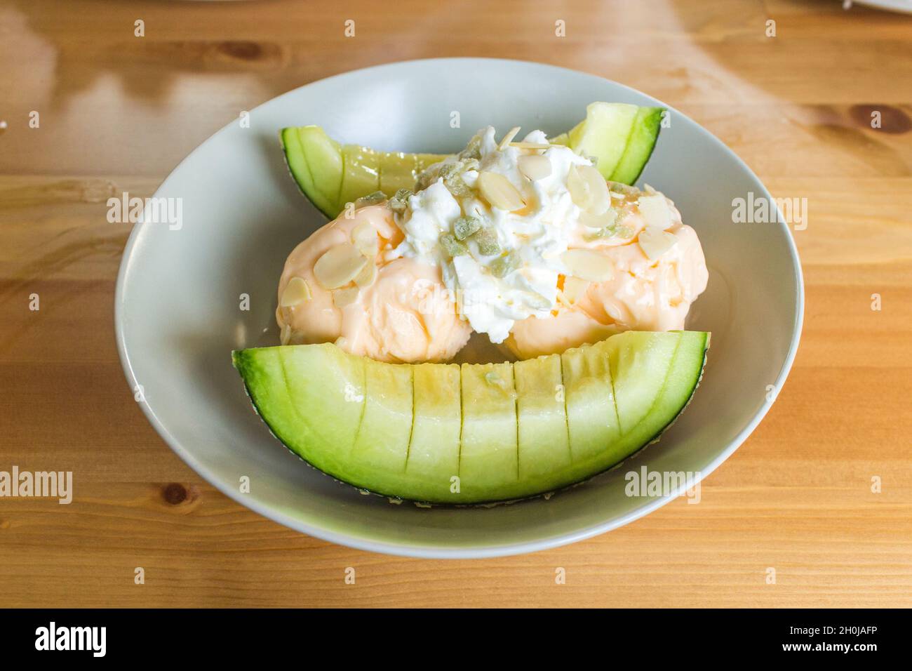 vanilla ice cream with melon piece Stock Photo - Alamy