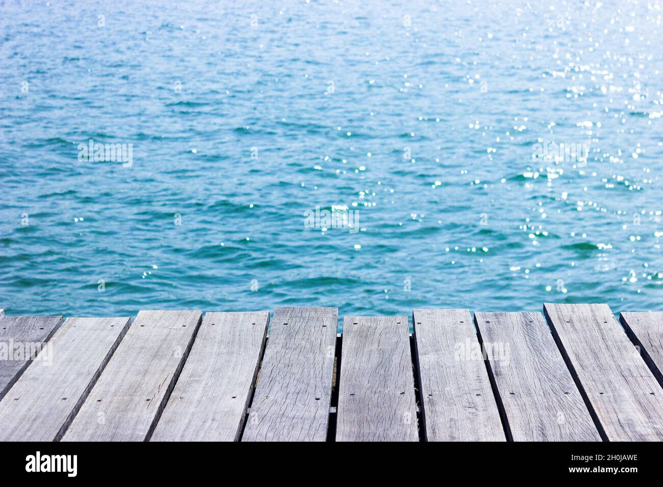 wooden table top with blue sea background Stock Photo - Alamy