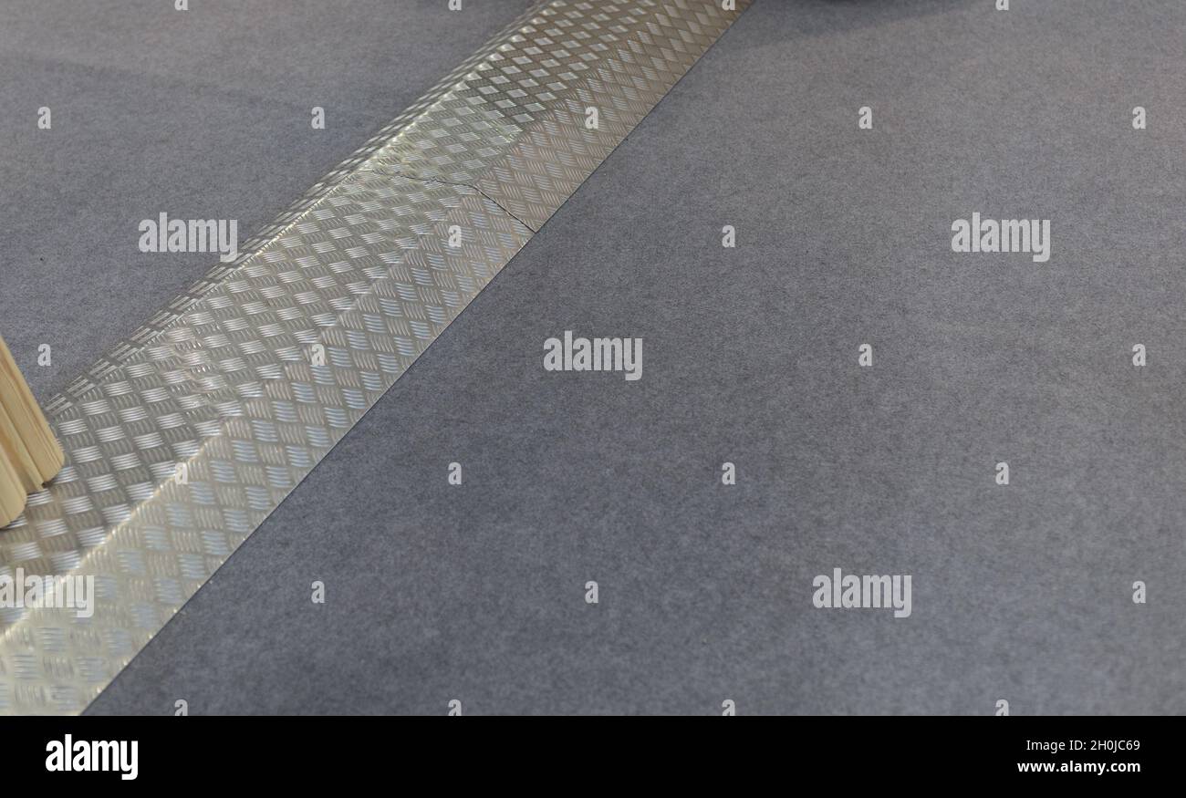Closeup shot of a steel speed bump on an asphalt ground Stock Photo - Alamy