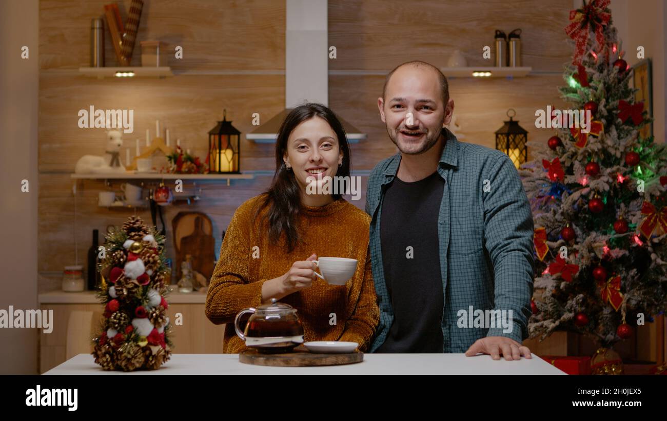 Couple using video call for festive communication with family at ...
