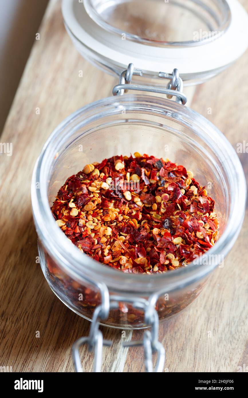 dried chilli flakes in a glass jar Stock Photo - Alamy