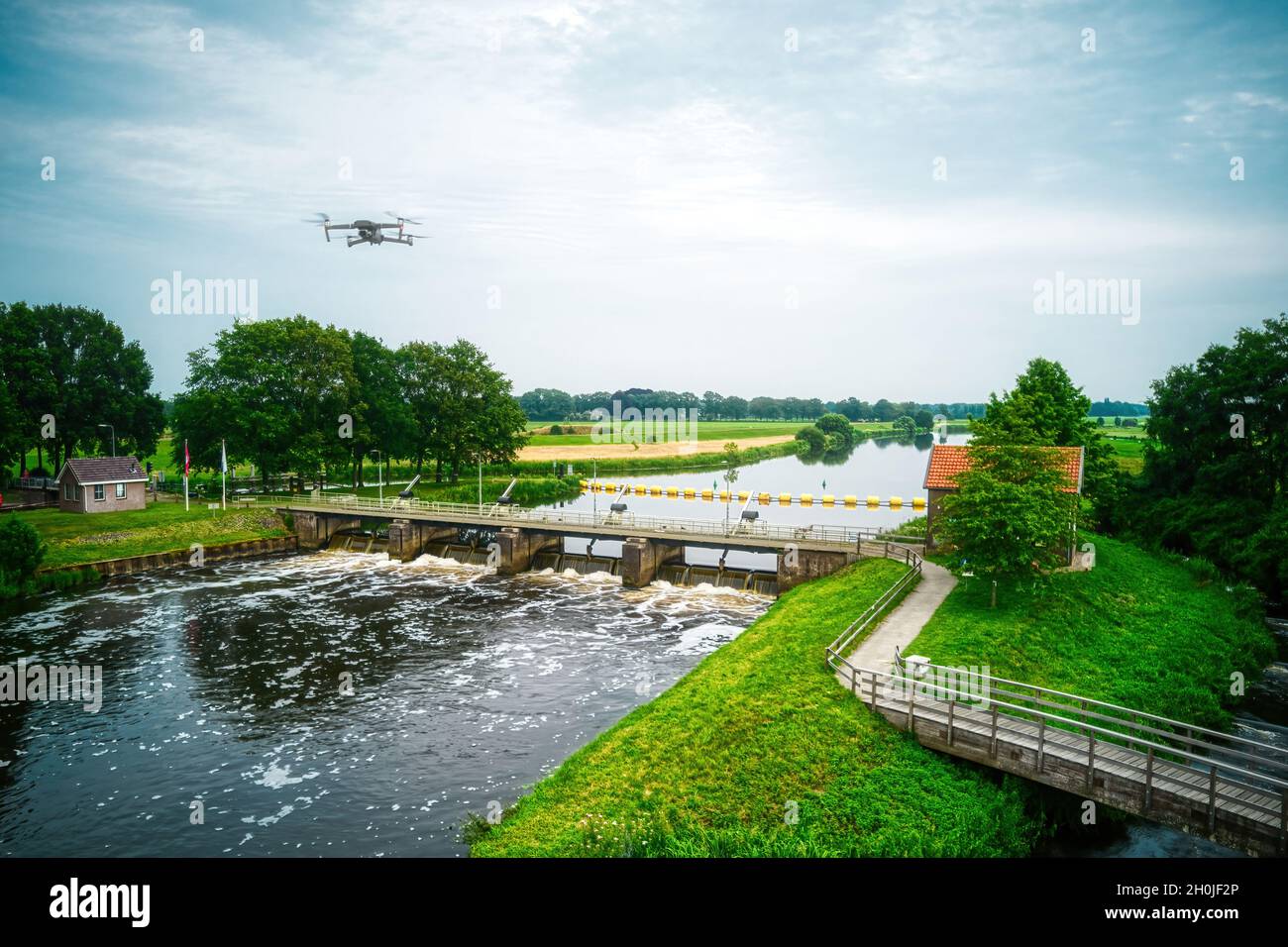 Water swirls from the weir in the river Vecht in the Netherlands ...