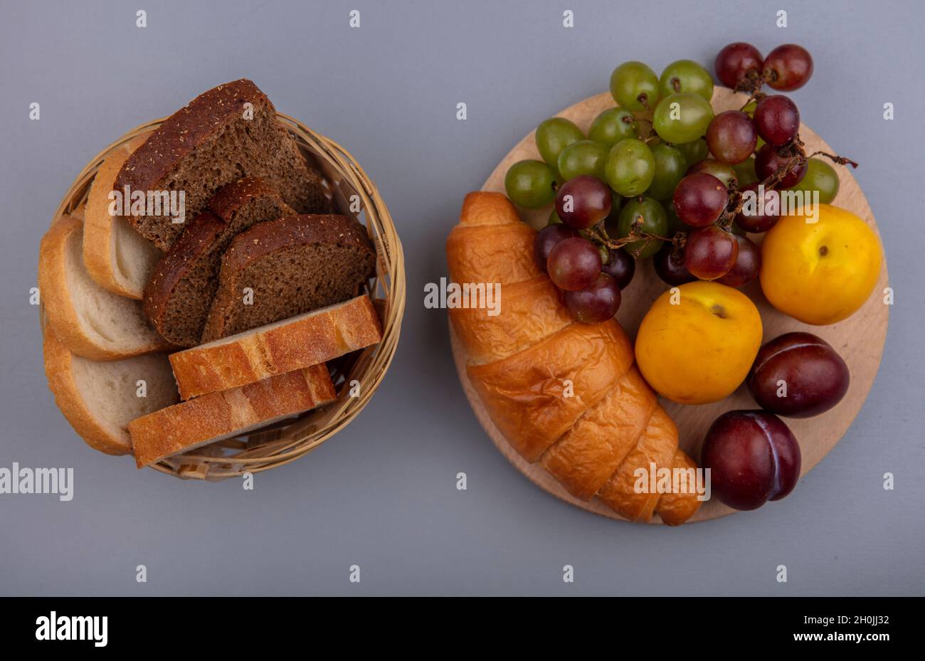 top view of fruits as grape nectacot and pluot with croissant on ...