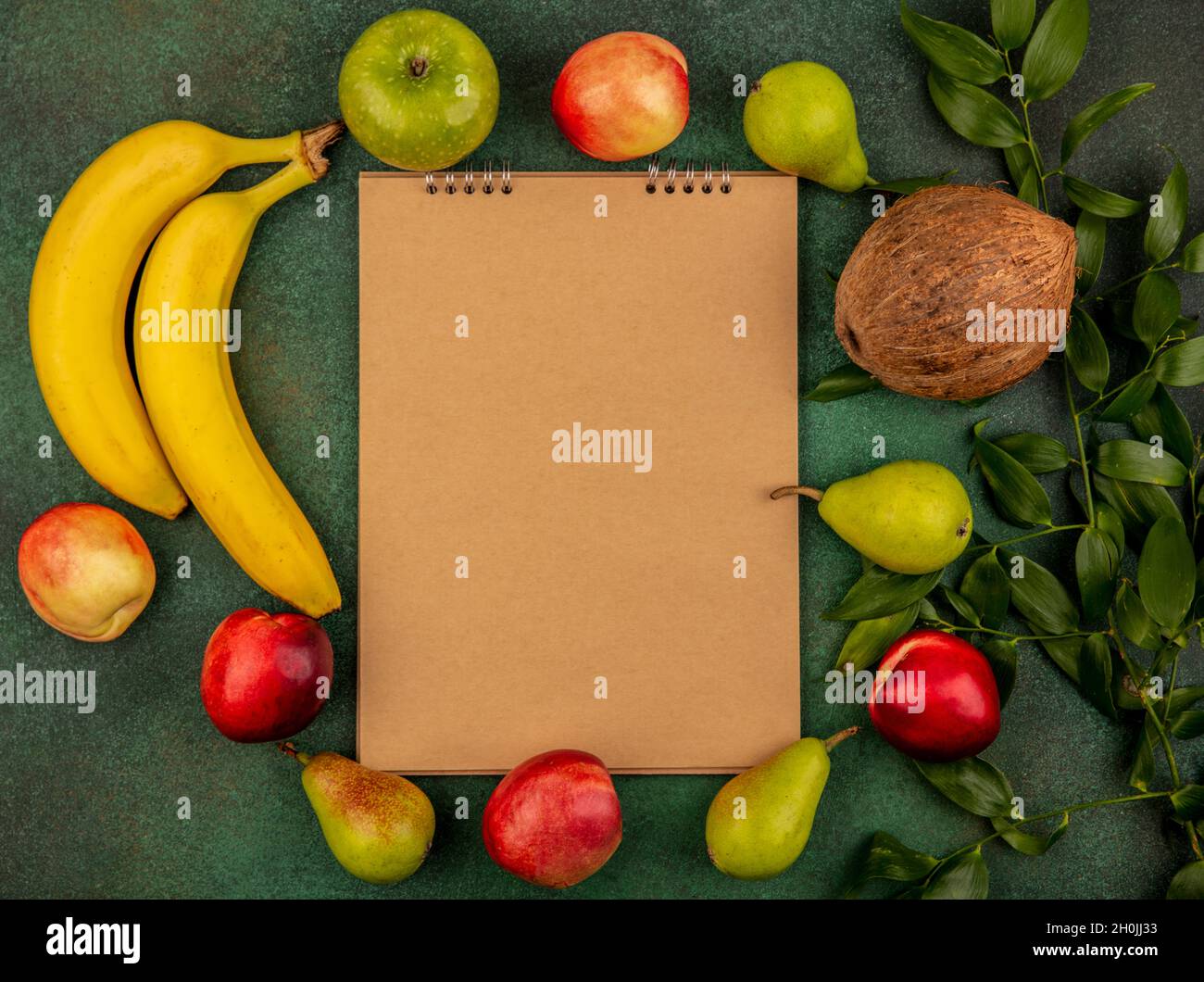 top view of fruits as peach coconut apple pear banana with leaves ...