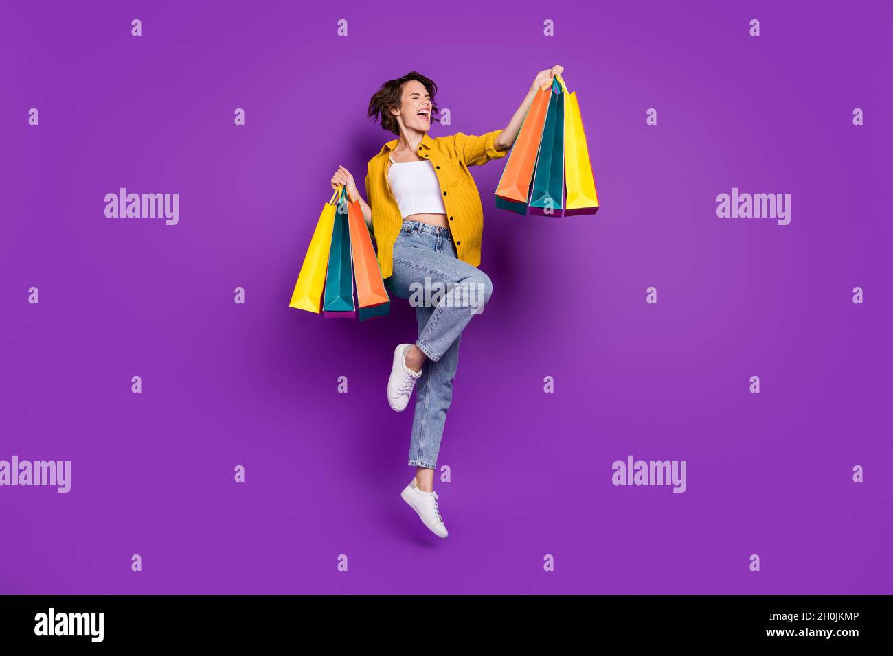 Full length body size view of attractive cheerful girl jumping carrying ...