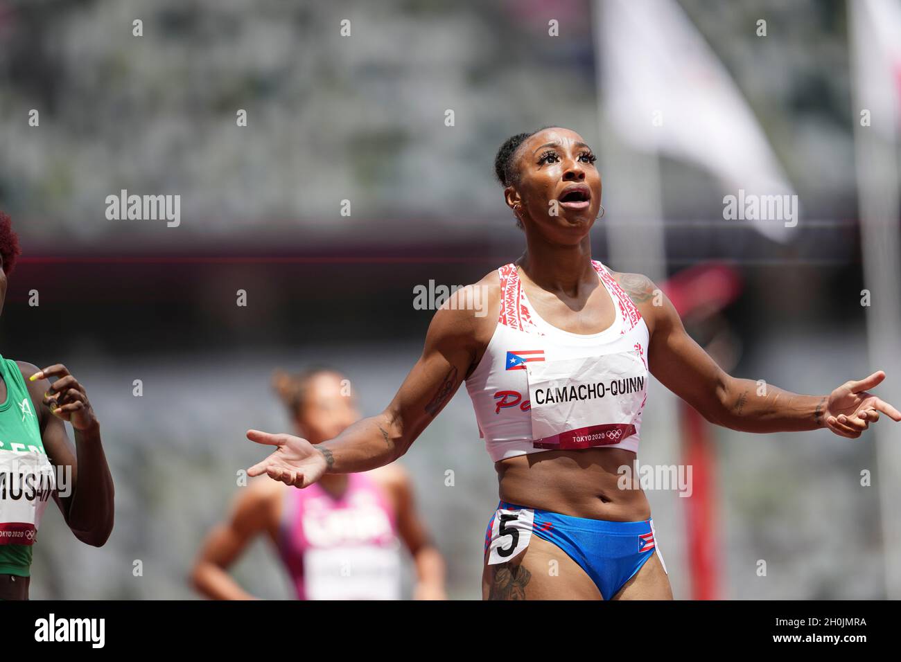 Jasmine Camacho-Quinn running and winning in the final of the 100 meter ...