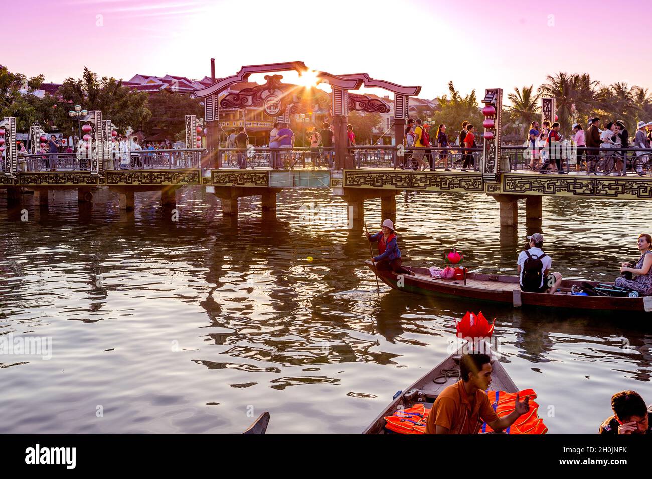 Many people walking across the main tourist bridge to old town tourists ...