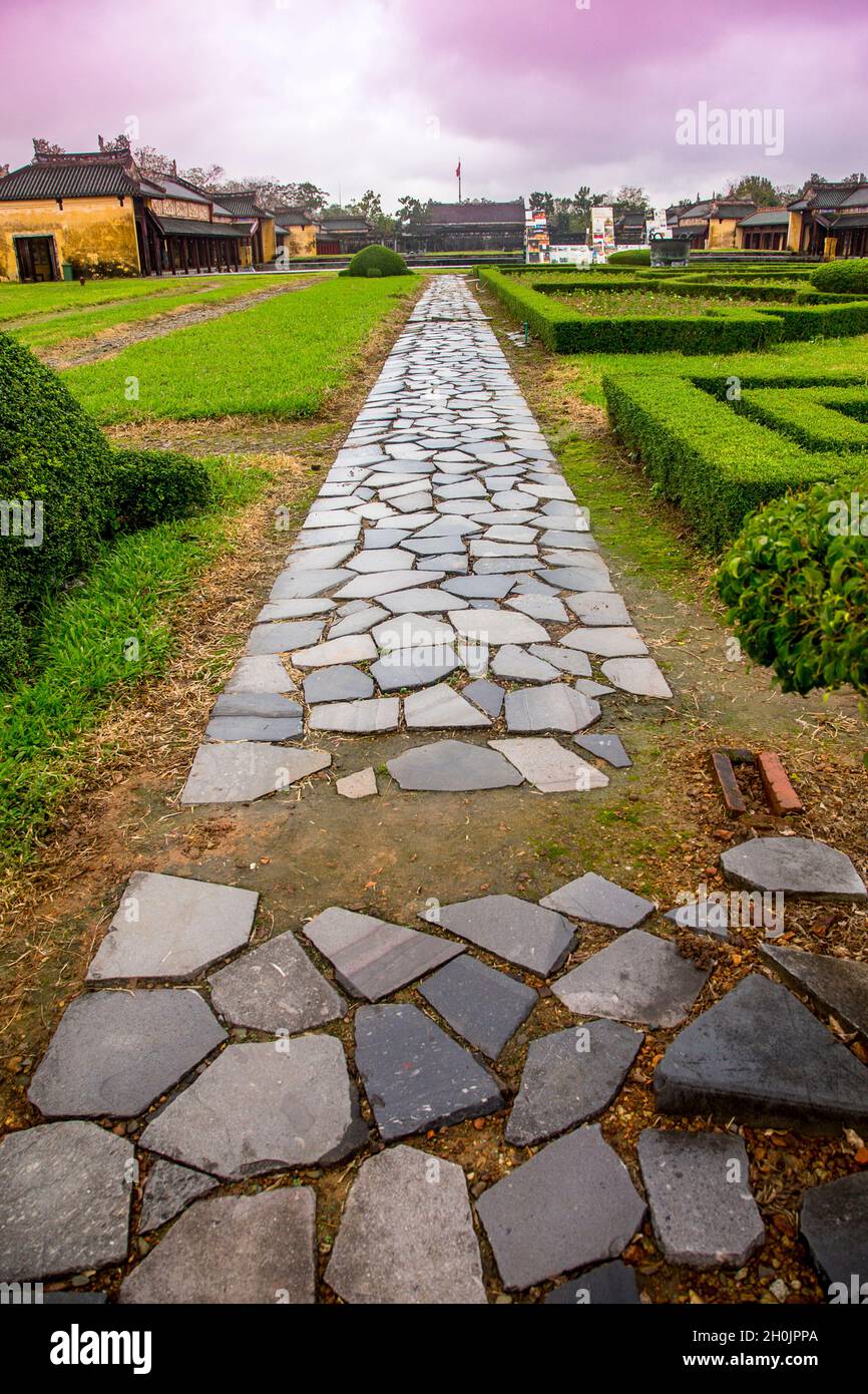 Long paved path with flat stones leading to buildings and tombs in Hue ...