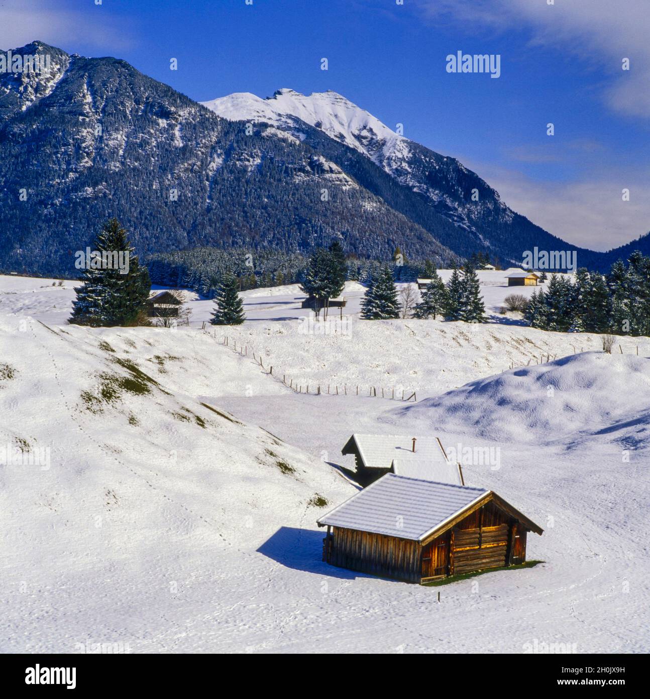 Wooden haystack in front of Karwendel mountains in winter, Germany ...